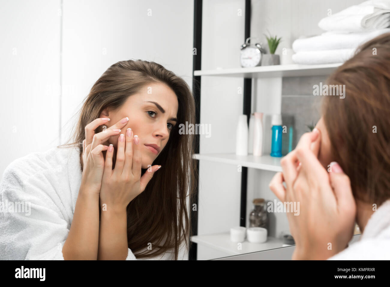 Woman checking face skin Stock Photo - Alamy