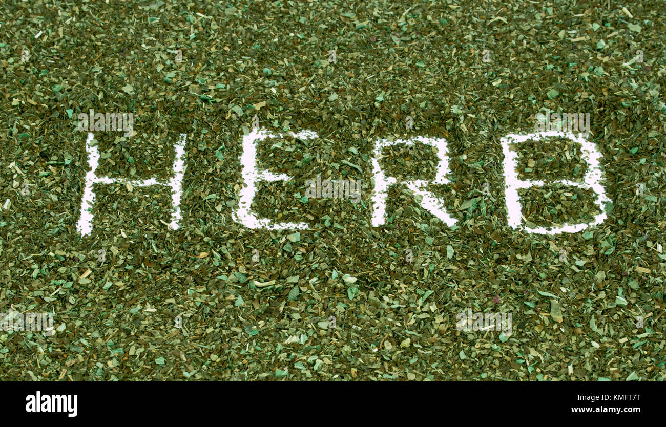 Word herb written with dried great basil leaves aromatic herbs isolated ...
