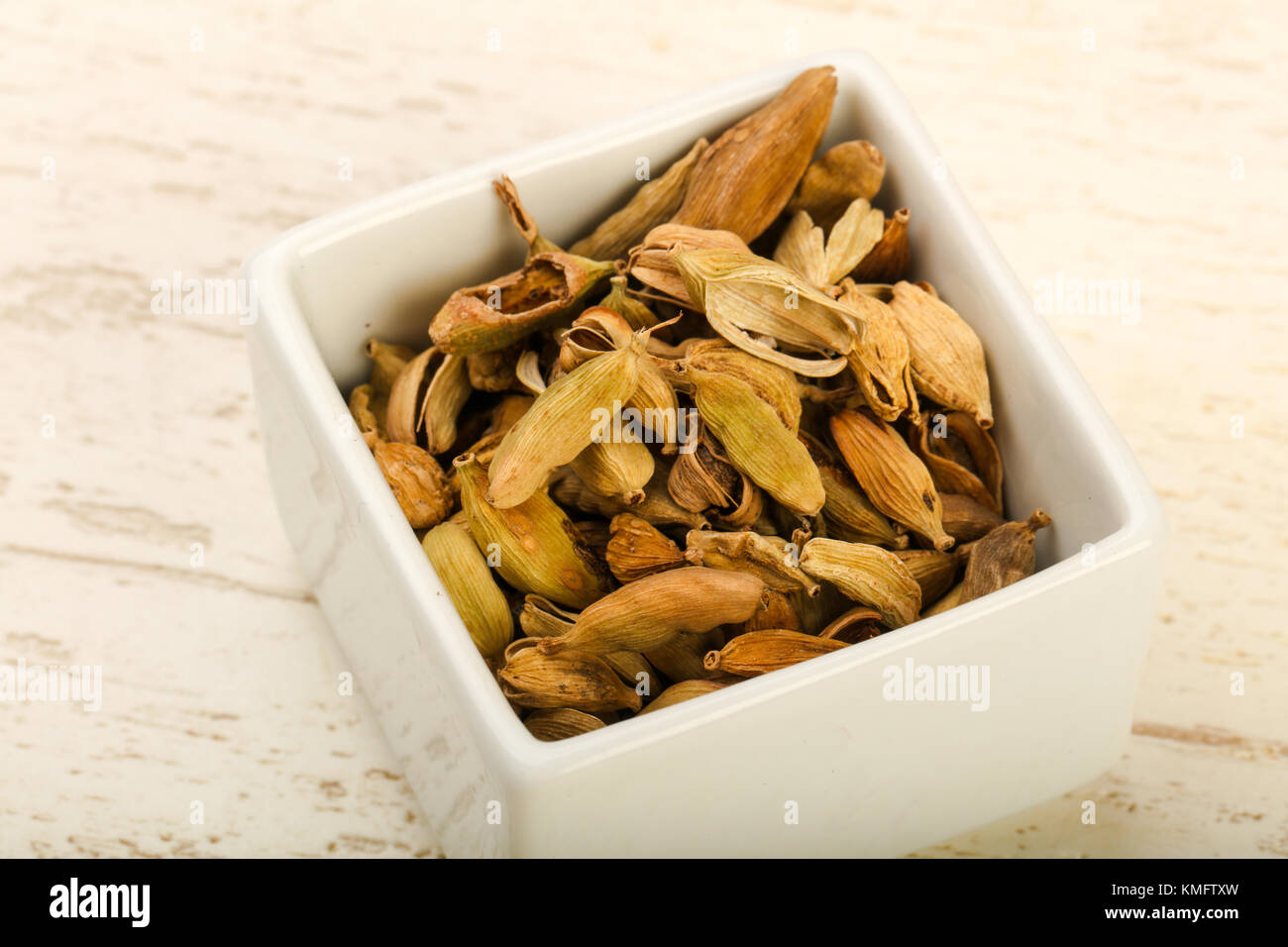 Dry cardamom seeds heap in the bowl Stock Photo - Alamy