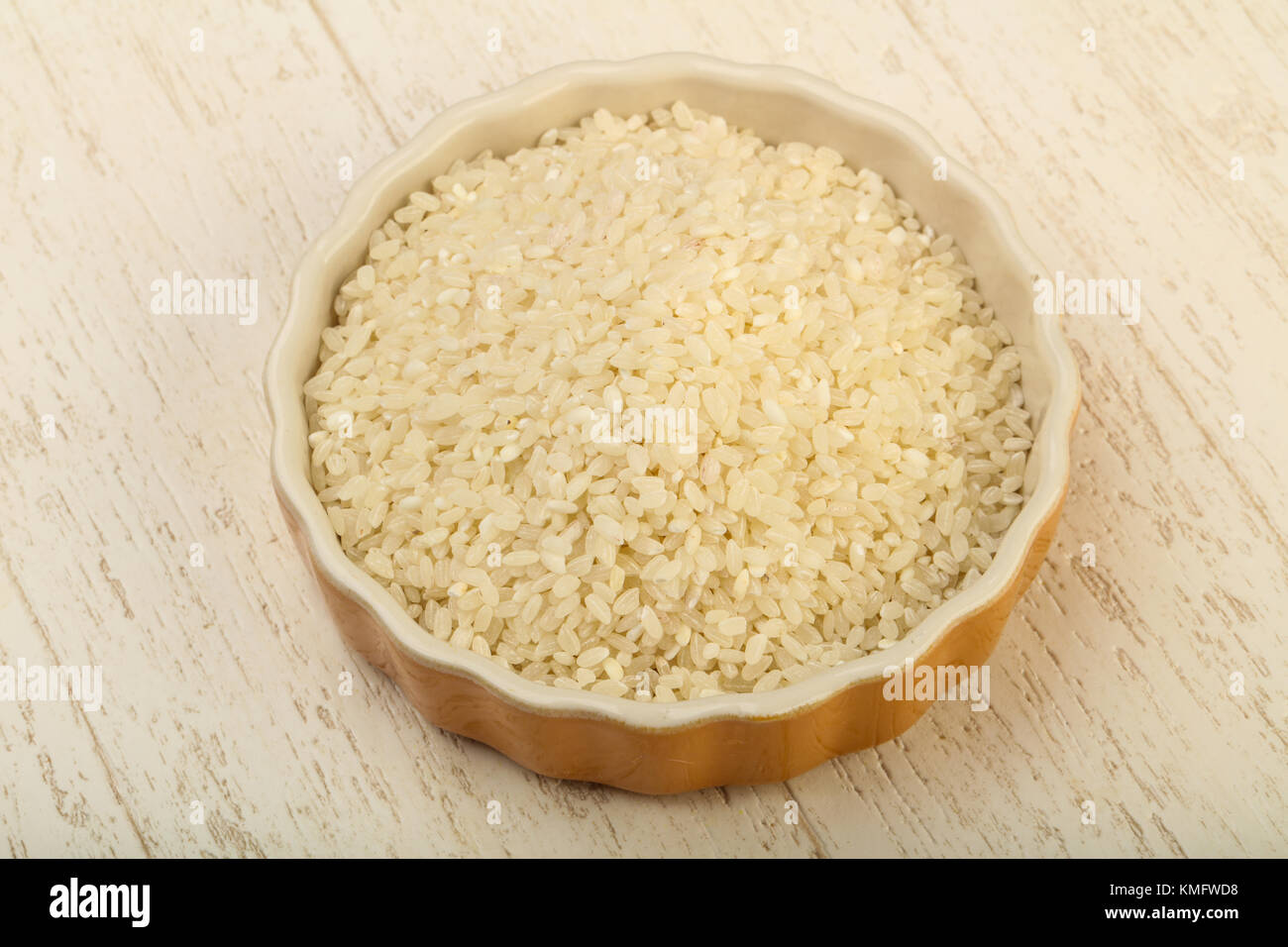 Raw rice heap in the bowl - ready for cooking Stock Photo - Alamy