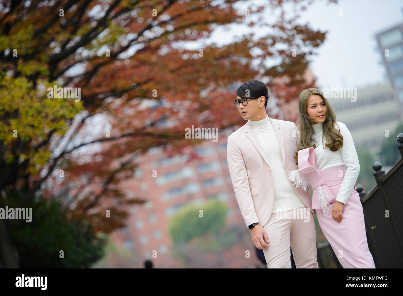 Young japanese couple in love stand together under autumn trees Stock ...