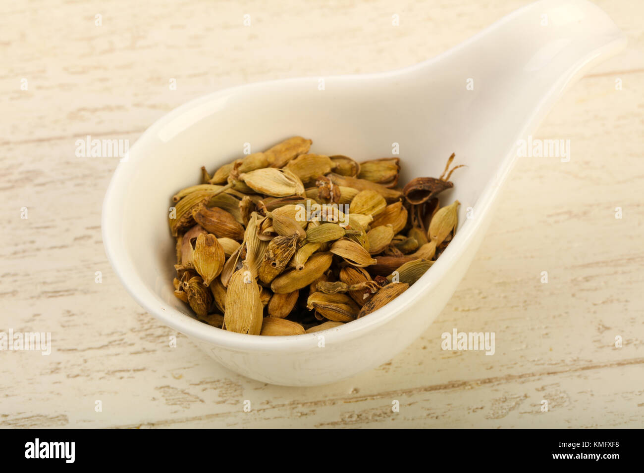 Dry cardamom seeds heap in the bowl Stock Photo - Alamy