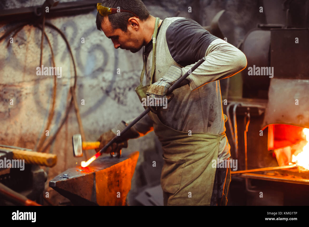 Blacksmith working on metal on anvil at forge high speed detail shot ...