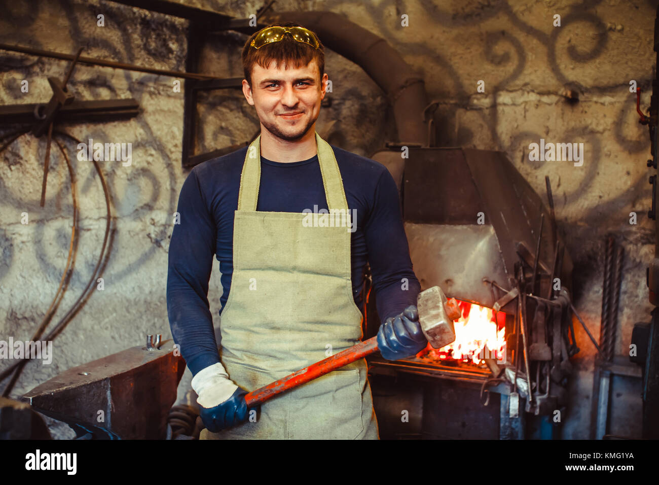 two forge are in working clothes in the forge Stock Photo - Alamy