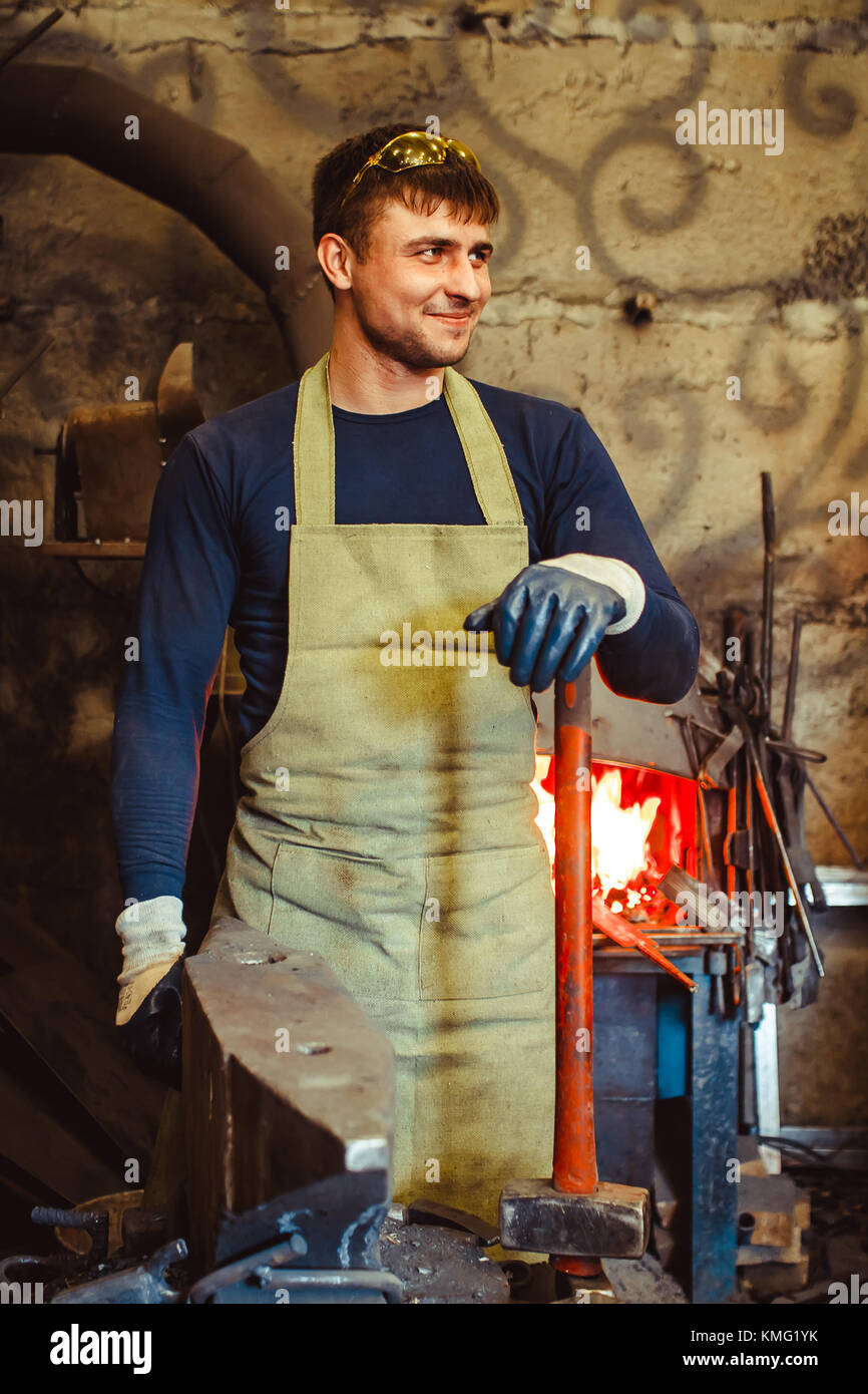 two forge are in working clothes in the forge Stock Photo - Alamy