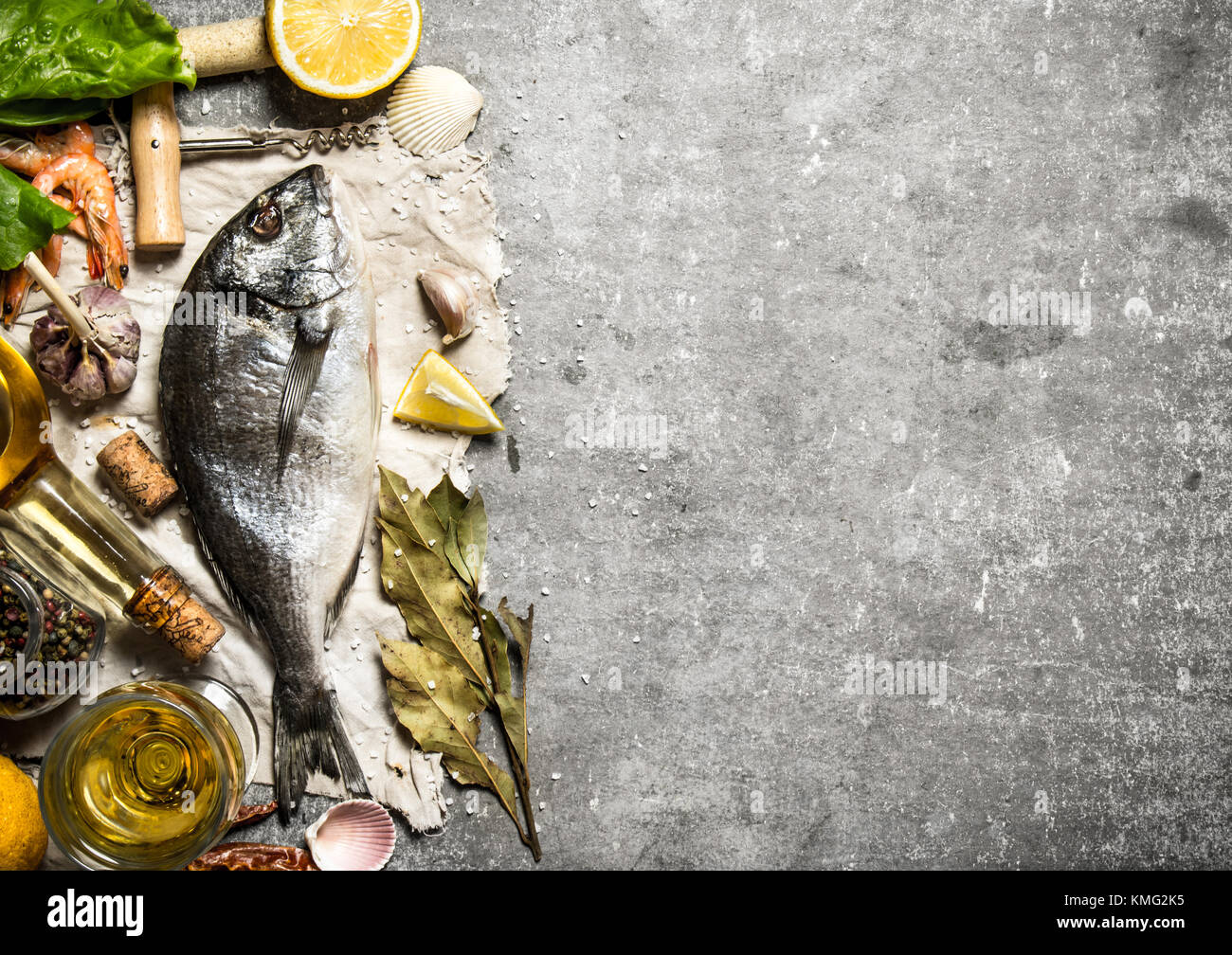 Fresh fish with spices and herbs. On a stone background Stock Photo - Alamy