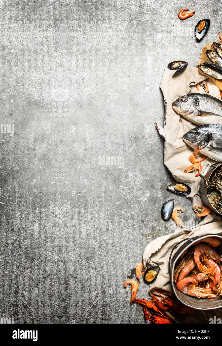 Fresh seafood. Fresh shrimp, fish and shellfish. On a stone background ...