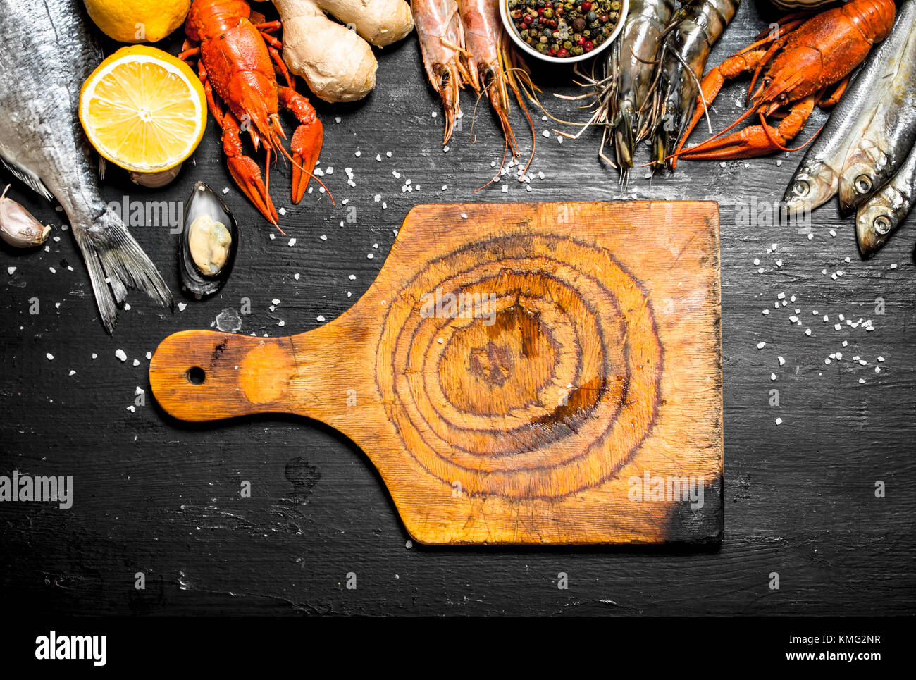 Fresh seafood. Cutting Board with a variety of shrimp, fish and ...