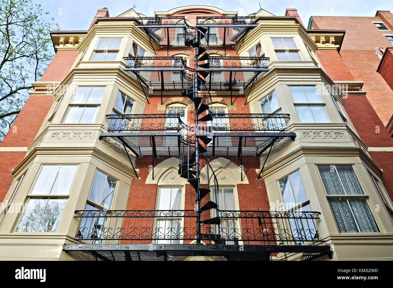 Fire escape and bay windows of victorian apartment building. Boston ...
