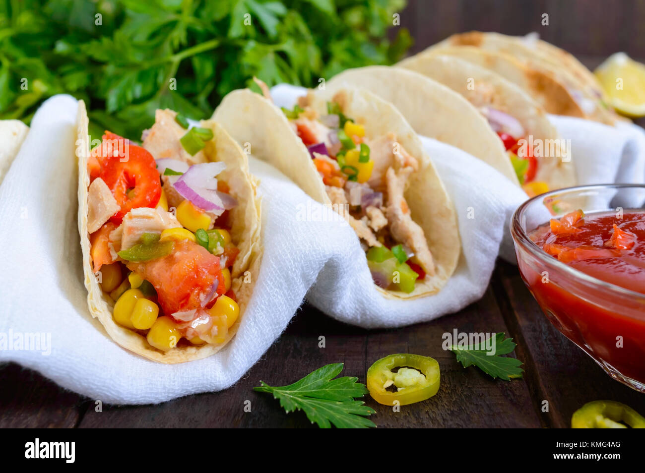 Mexican tacos with meat, corn, tomatoes, sweet pepper, red onions in a ...