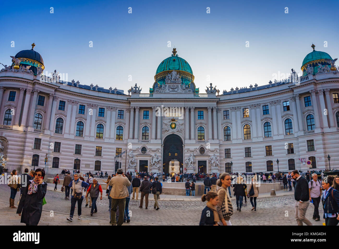 Walking around the crowded St. Michael Square in Hofburg Palace. It has ...