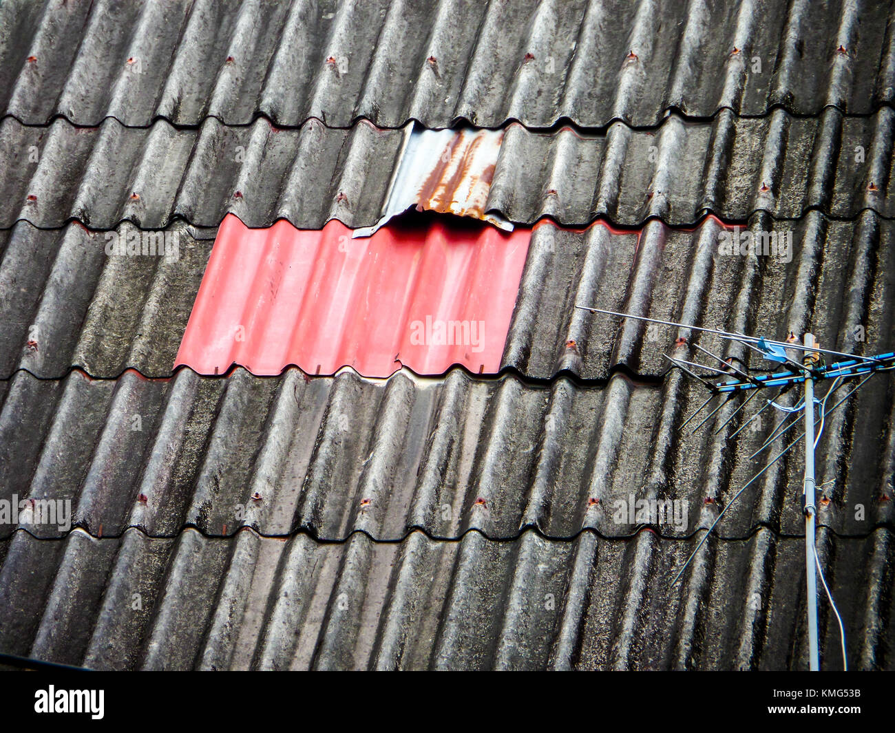 old roof repairing by red roof color and old zinc Stock Photo - Alamy