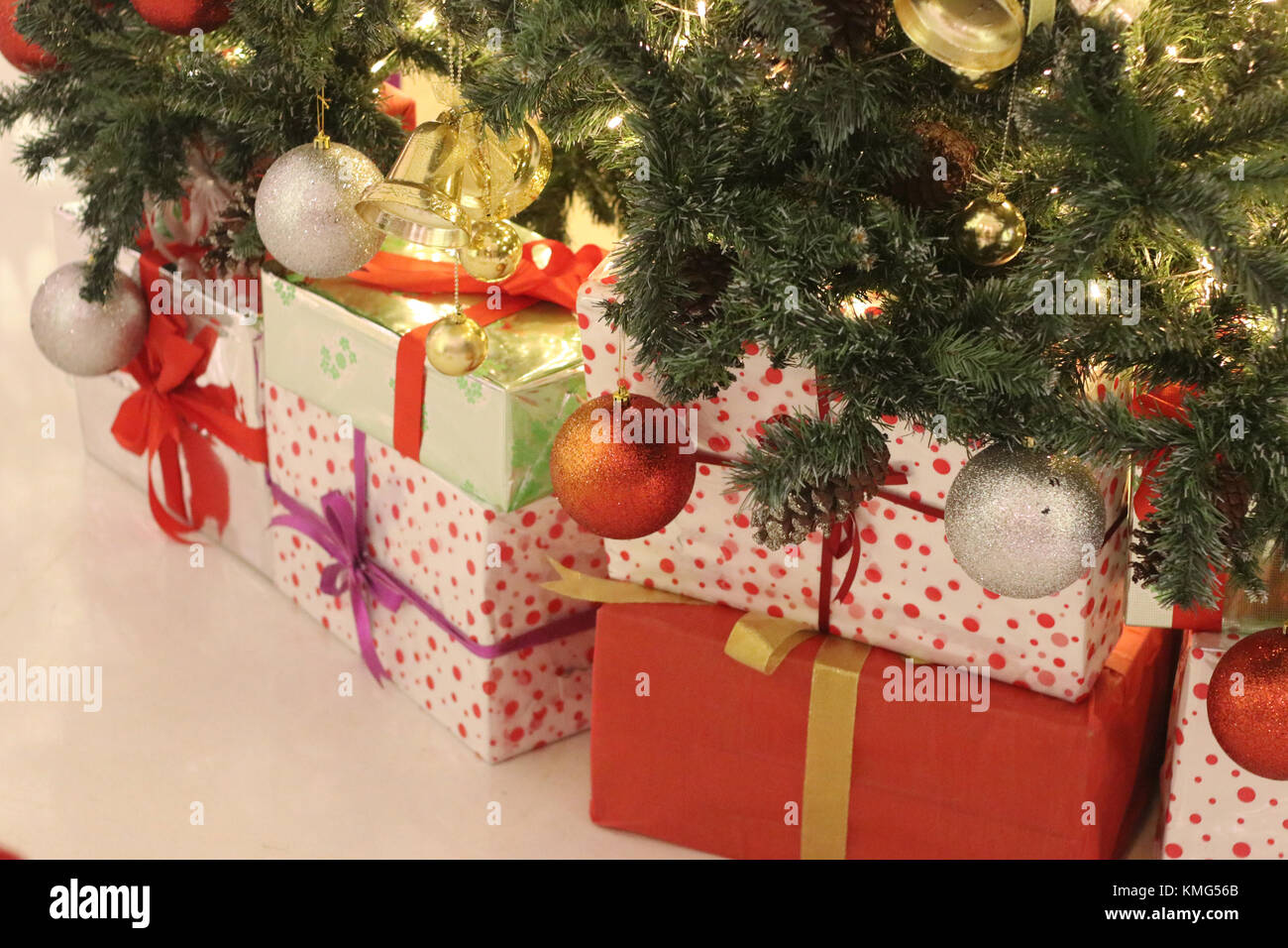 Christmas presents under Christmas decorated tree Stock Photo - Alamy