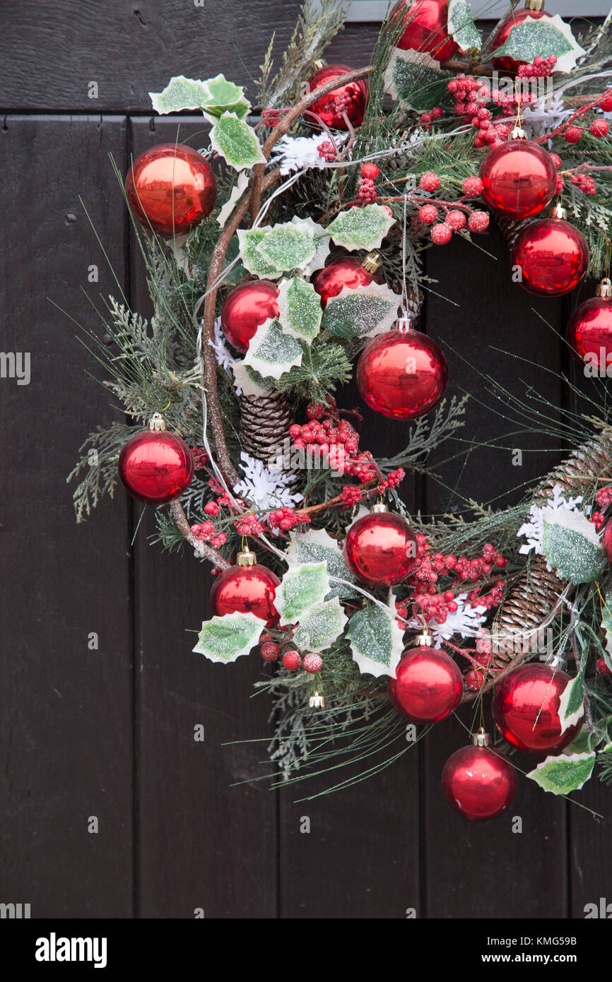 Red Ball Christmas Reef Decoration on Front Door Stock Photo - Alamy