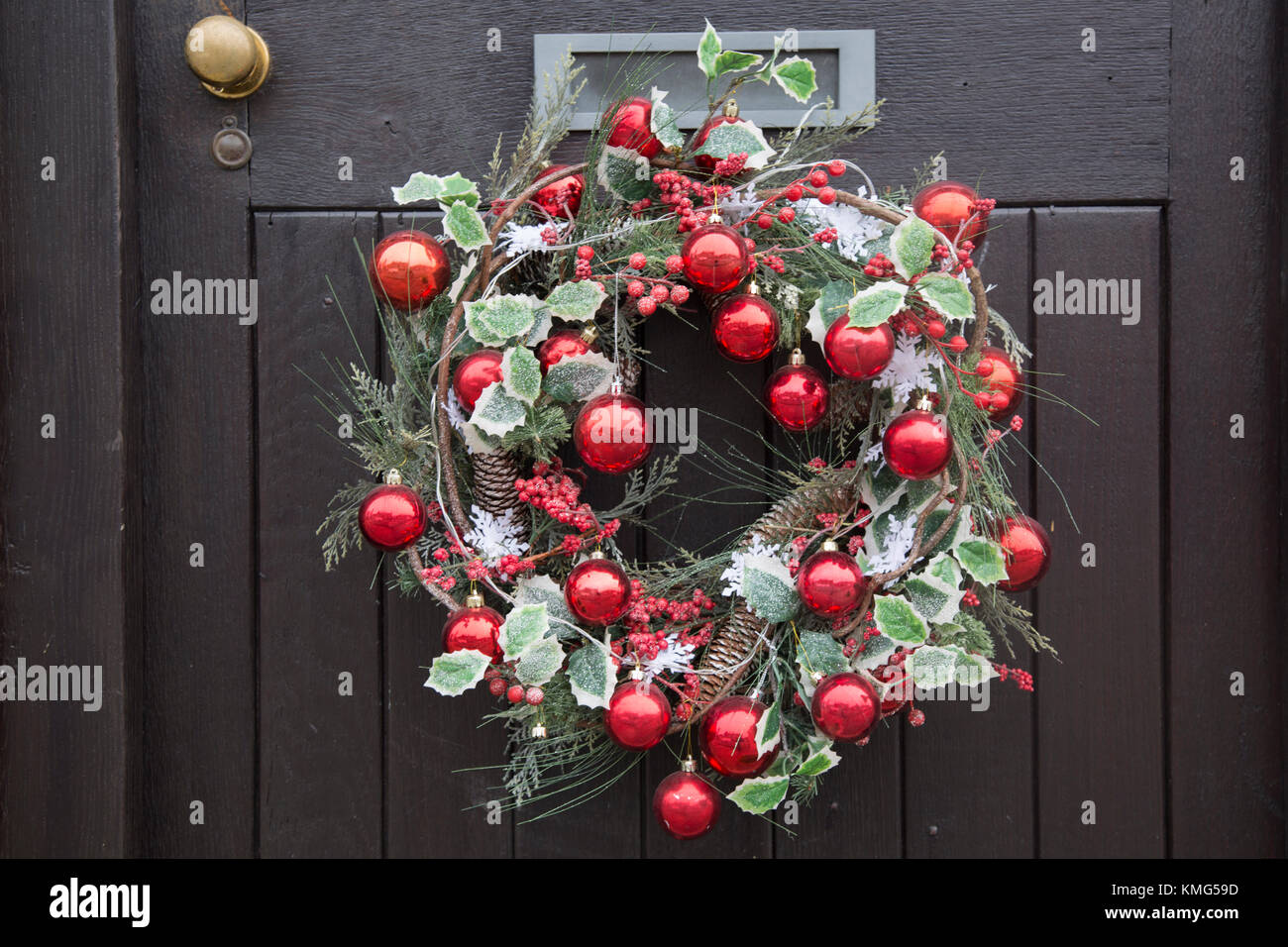 Red Ball Christmas Reef Decoration on Front Door Stock Photo - Alamy