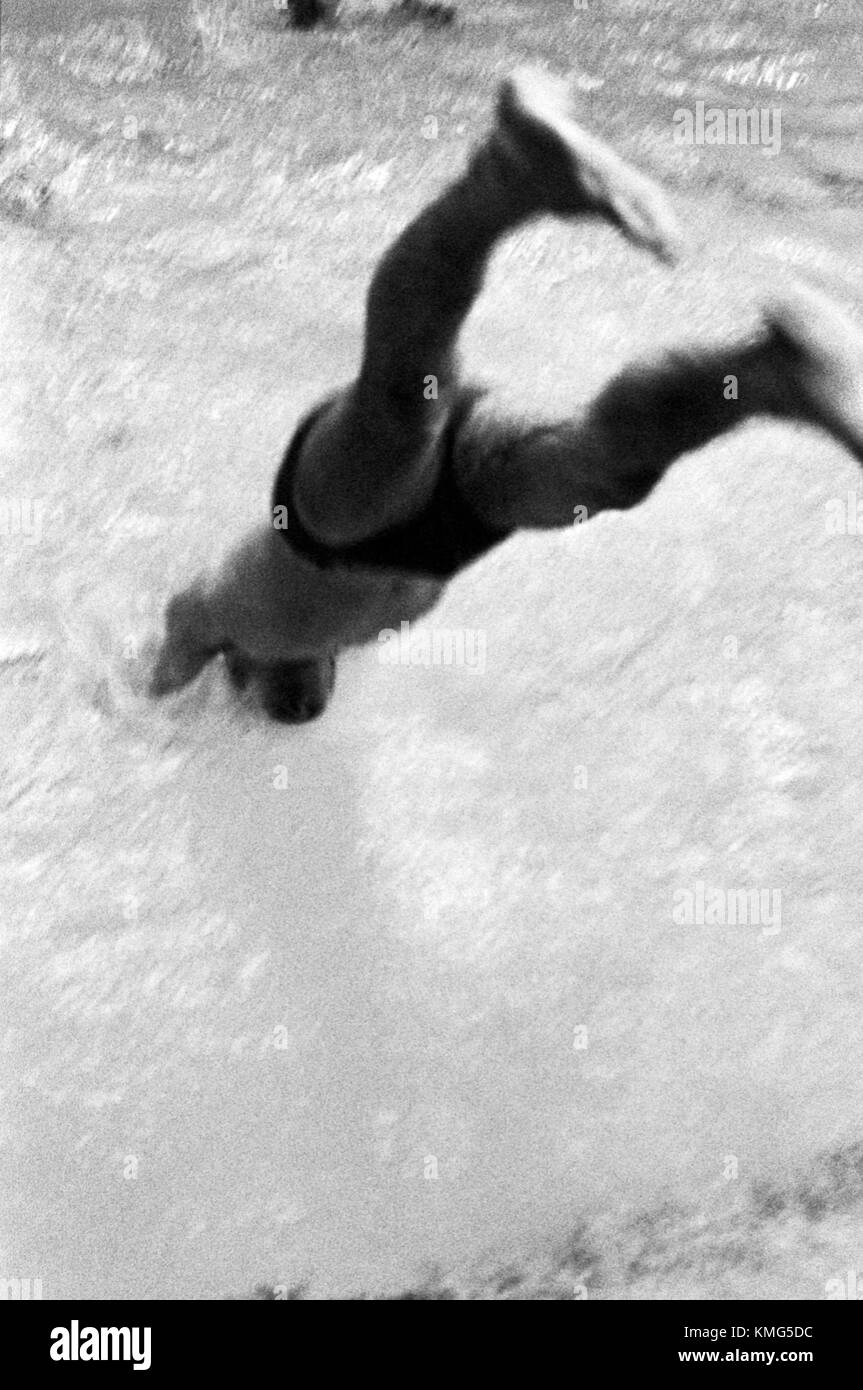 Person diving into swimming pool Black and White Stock Photos & Images ...