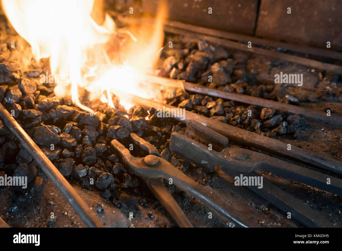 Blacksmith's pliers for forging iron bar in furnace Stock Photo - Alamy