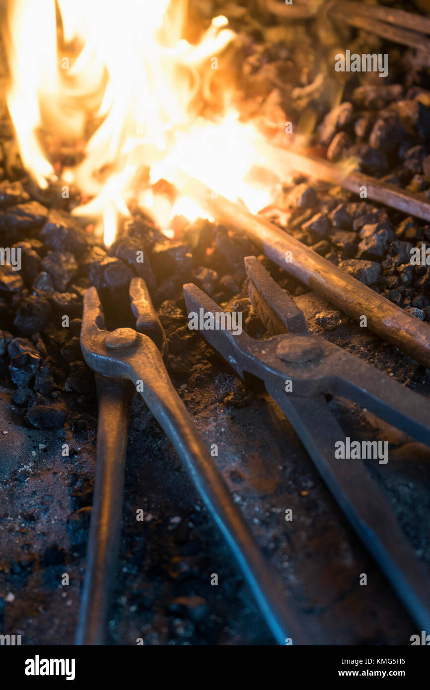 Blacksmith's pliers for forging iron bar in furnace Stock Photo - Alamy
