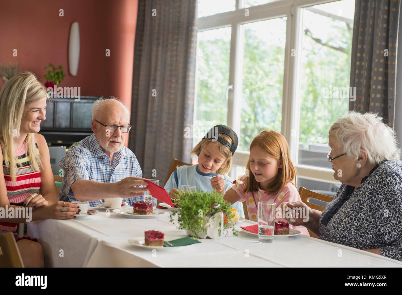 Family eating cake at rest home Stock Photo - Alamy