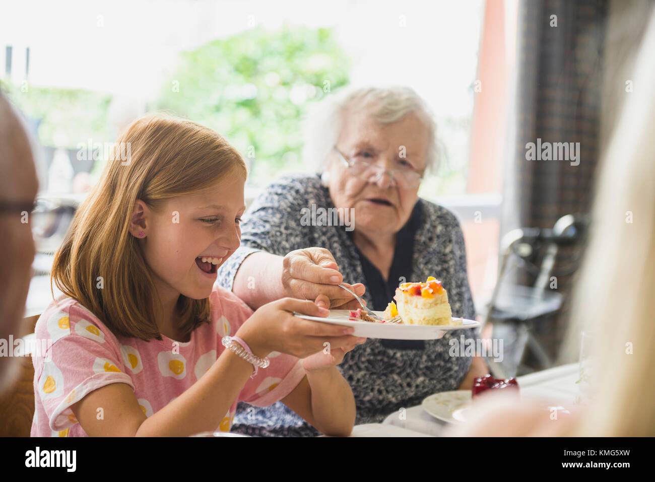 Family eating cake at rest home Stock Photo - Alamy