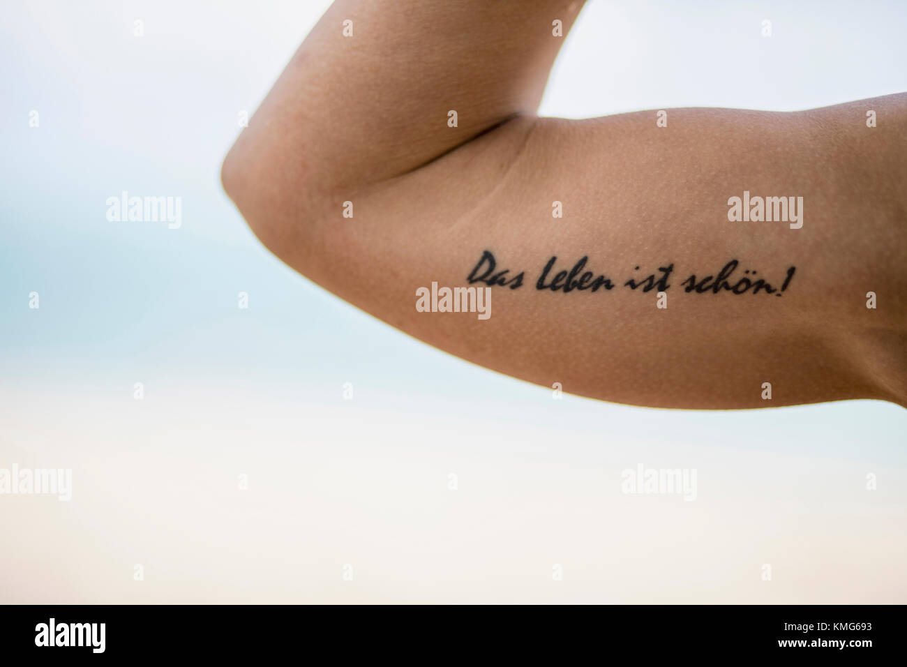Tattoo on arm "life is wonderful Stock Photo - Alamy