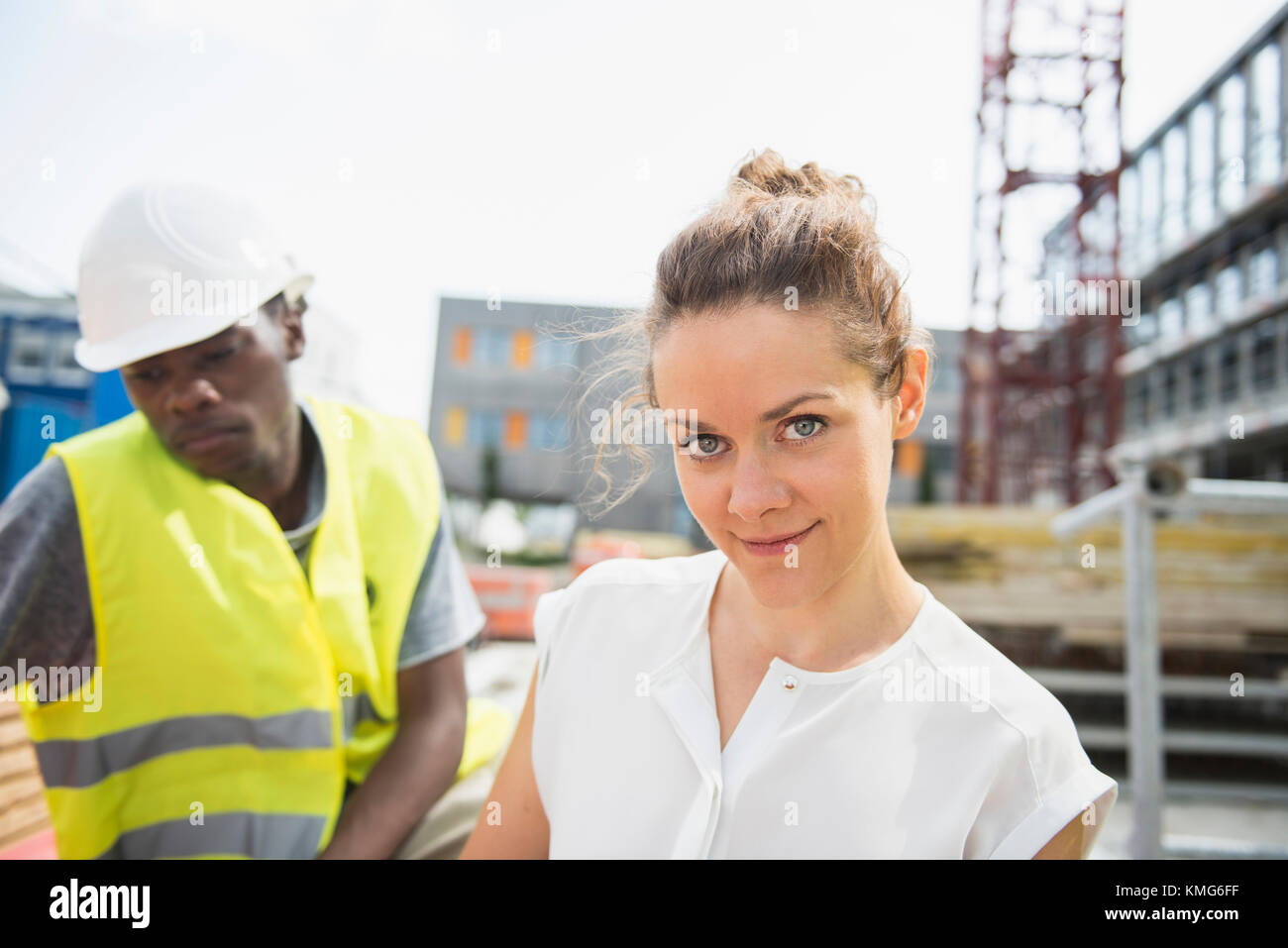 Architect with construction worker at building site Stock Photo - Alamy