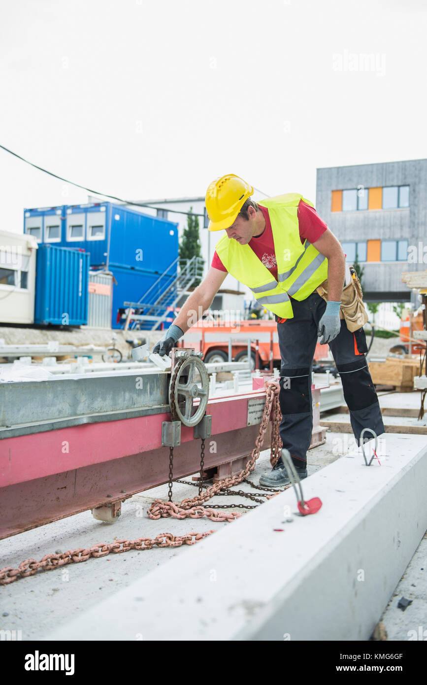 Construction worker at building site Stock Photo - Alamy