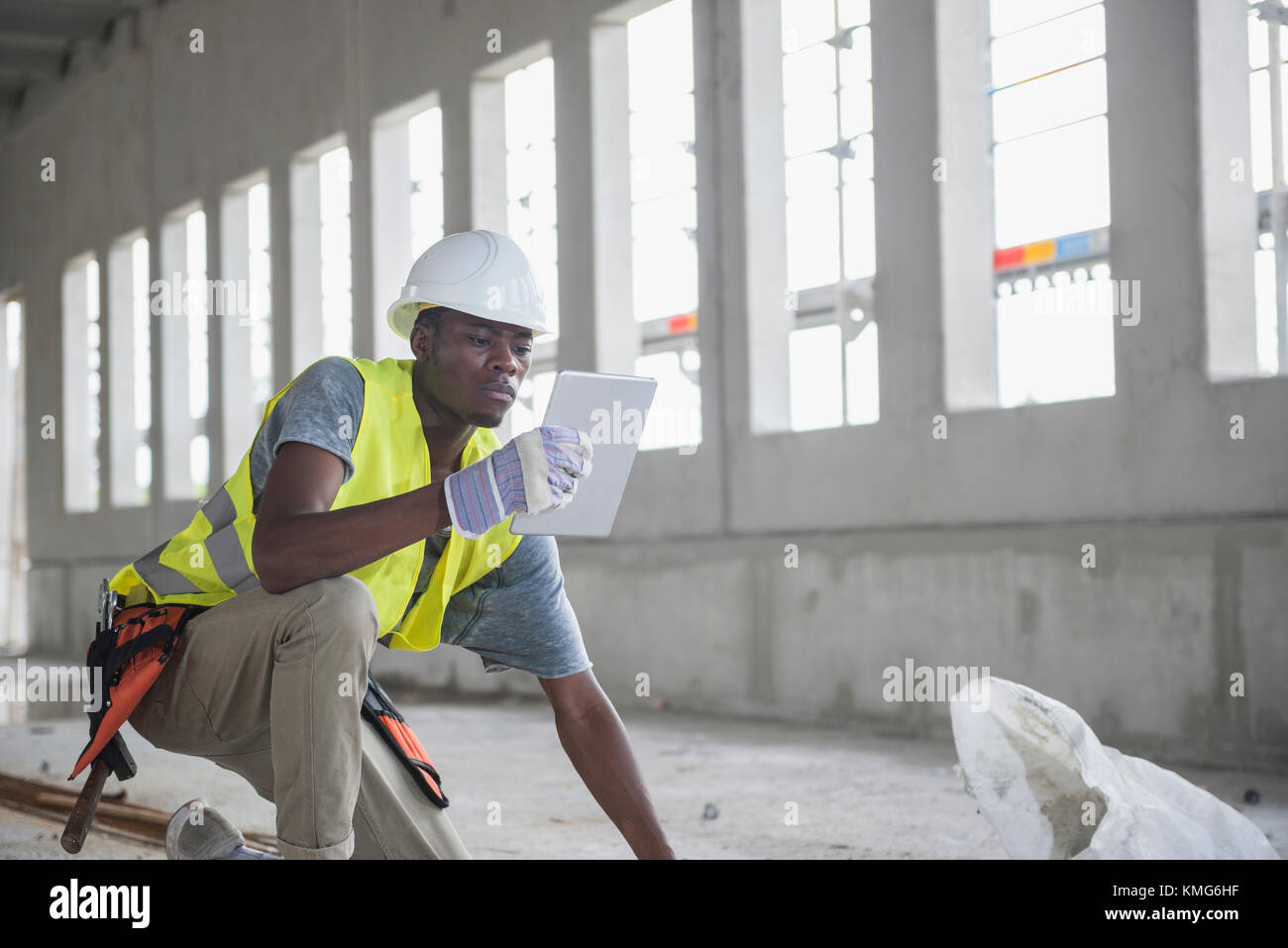 Construction worker using digital tablet at building site Stock Photo ...