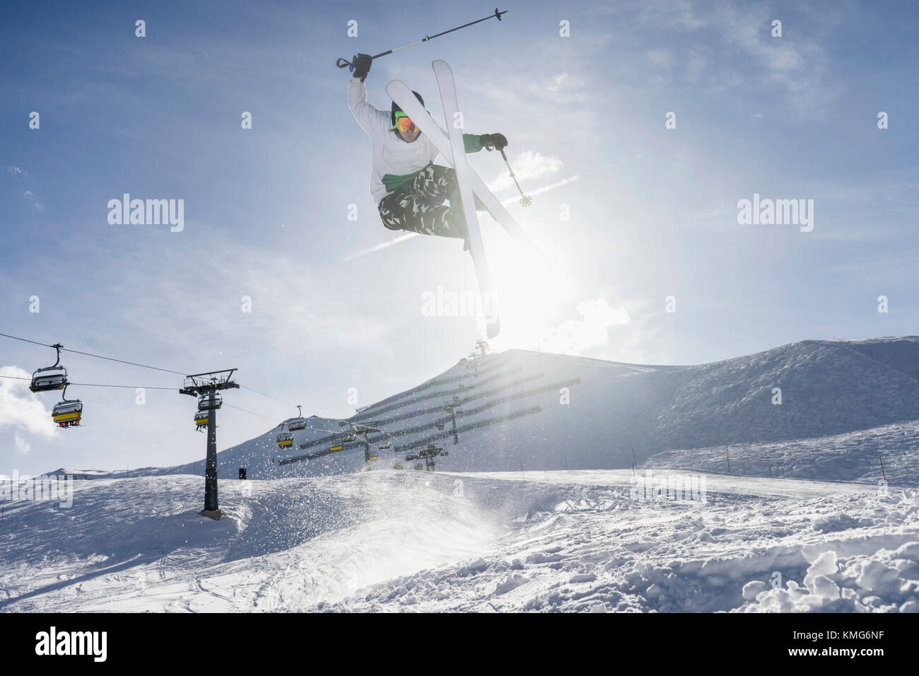 Skier jumping on snowcapped mountain Stock Photo - Alamy
