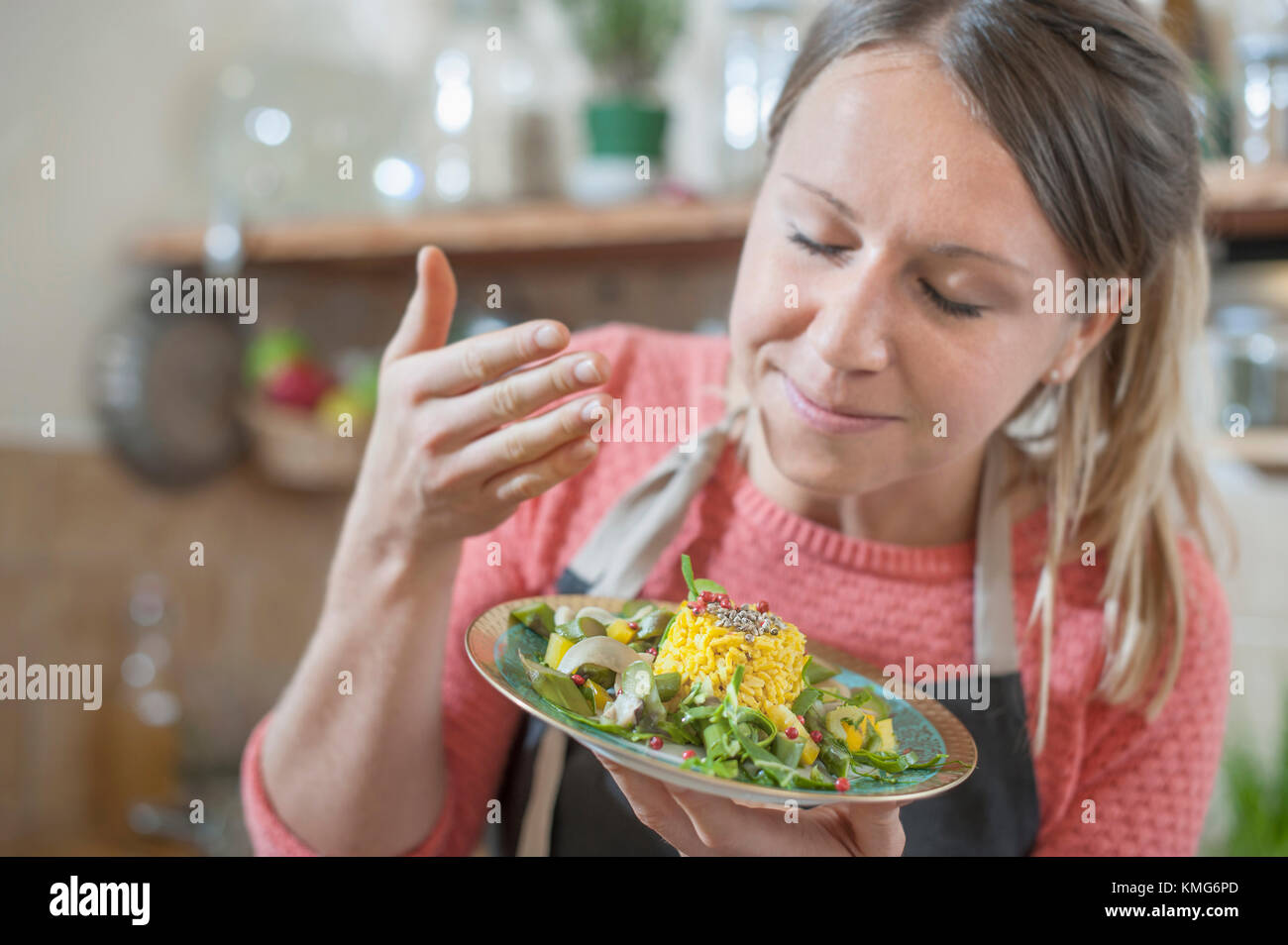 Young woman taking a smell on garnished rice dish Stock Photo - Alamy