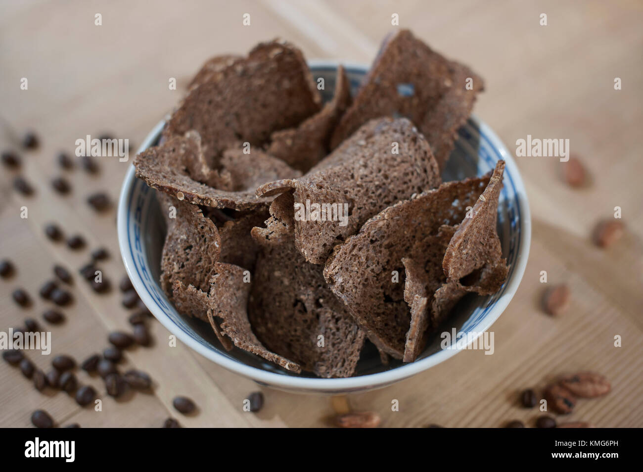 Bowl of brown bread chips with roasted coffee beans Stock Photo - Alamy
