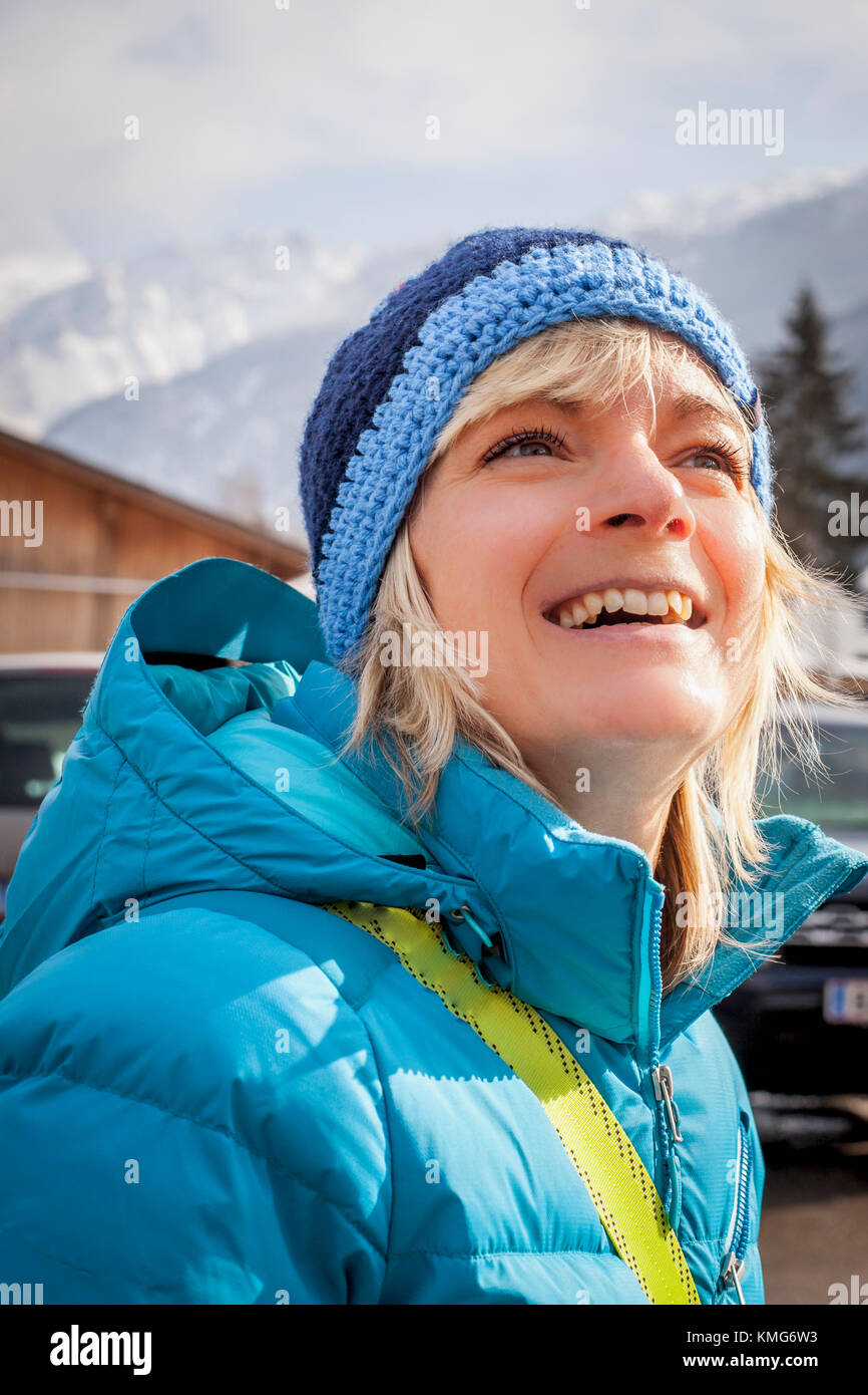 Happy woman in warm clothing at alps Stock Photo - Alamy