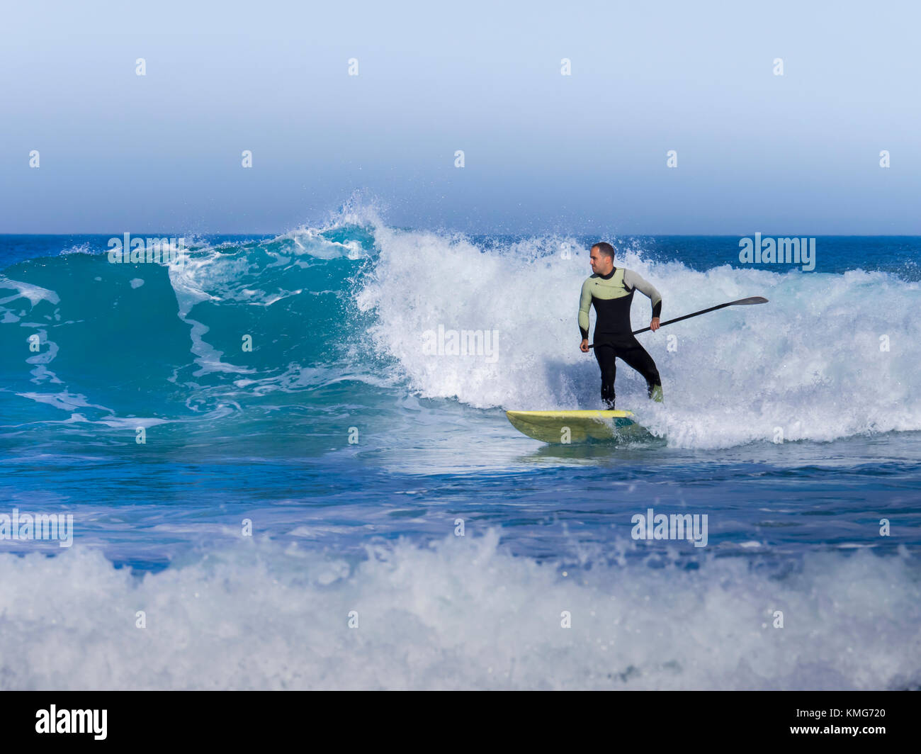 Man surfing with a stand up paddling Board at sopelana beach Stock ...