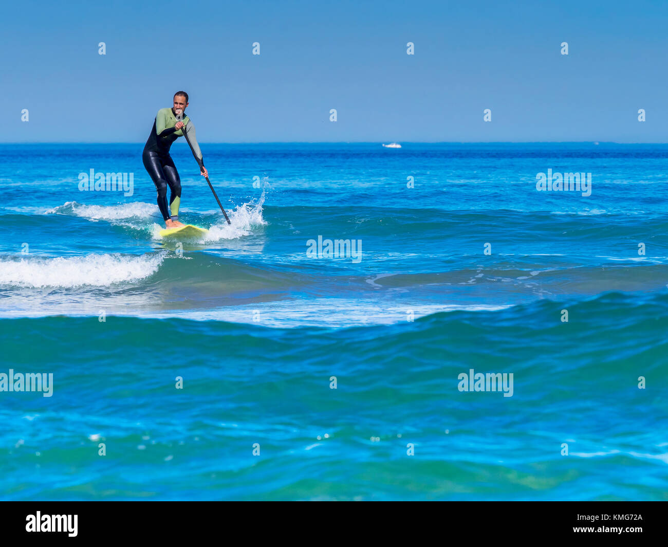 Man surfing with a stand up paddling board at sopelana beach Stock ...