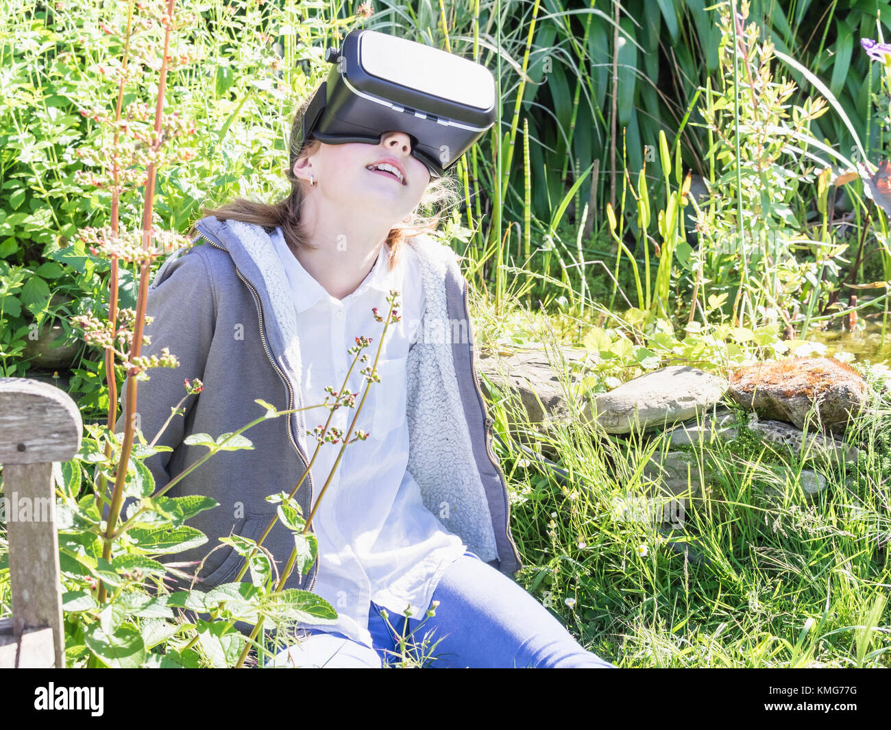 Girl using vr headset sitting hi-res stock photography and images - Alamy