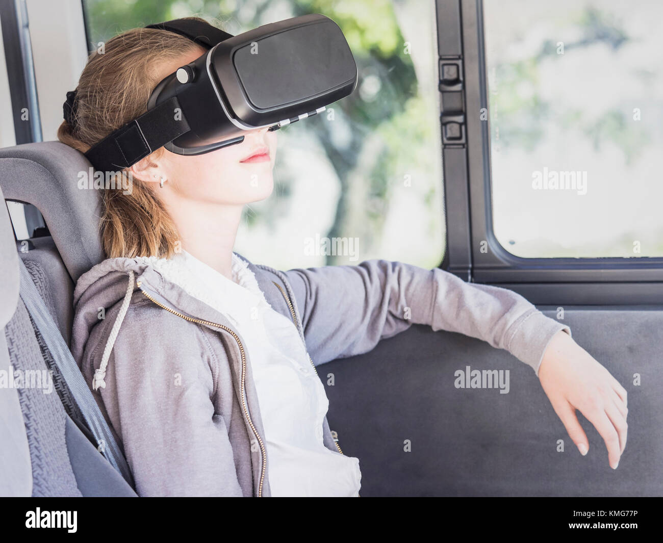 Girl using virtual reality headset in car Stock Photo - Alamy