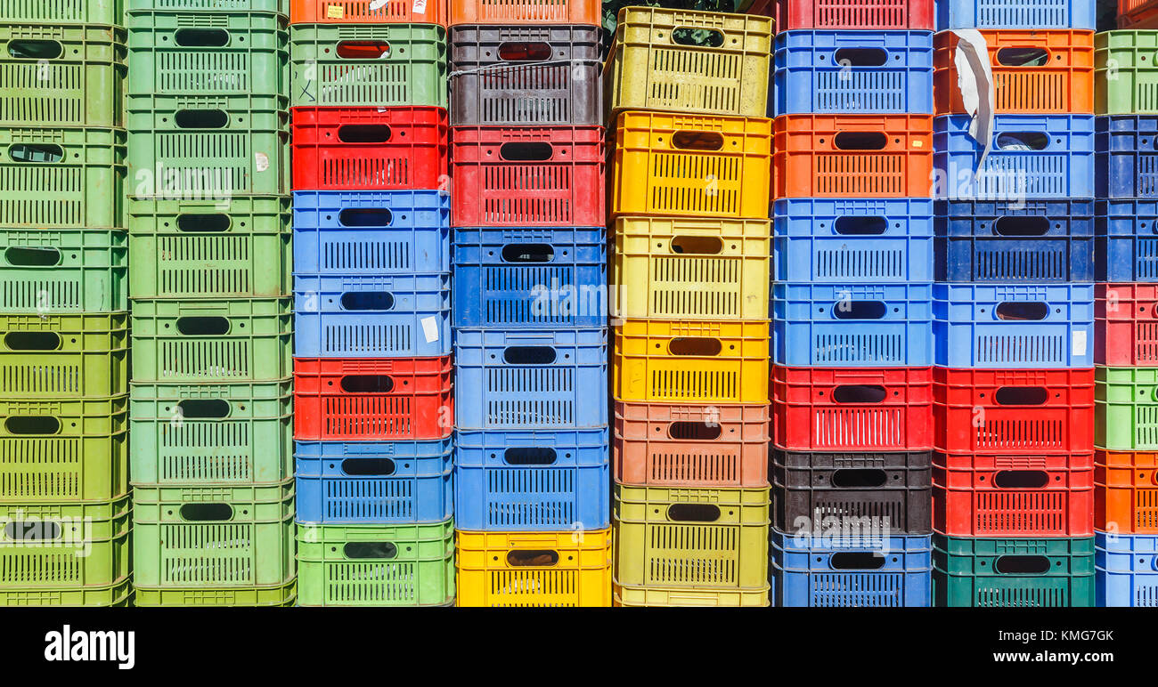 Colored plastic boxes for fruit stacked in piles Stock Photo - Alamy