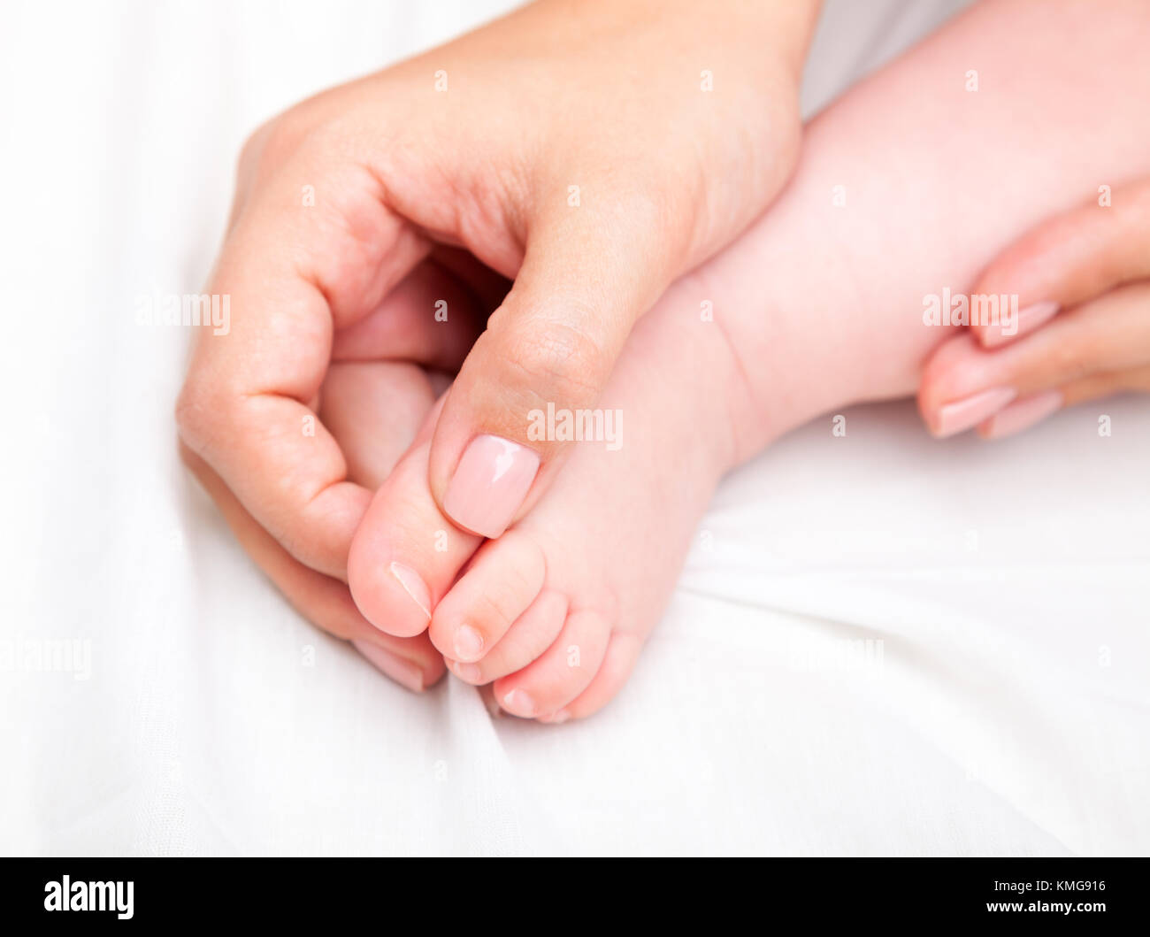 Seven month baby girls foot joint being manipulated by osteopathic ...