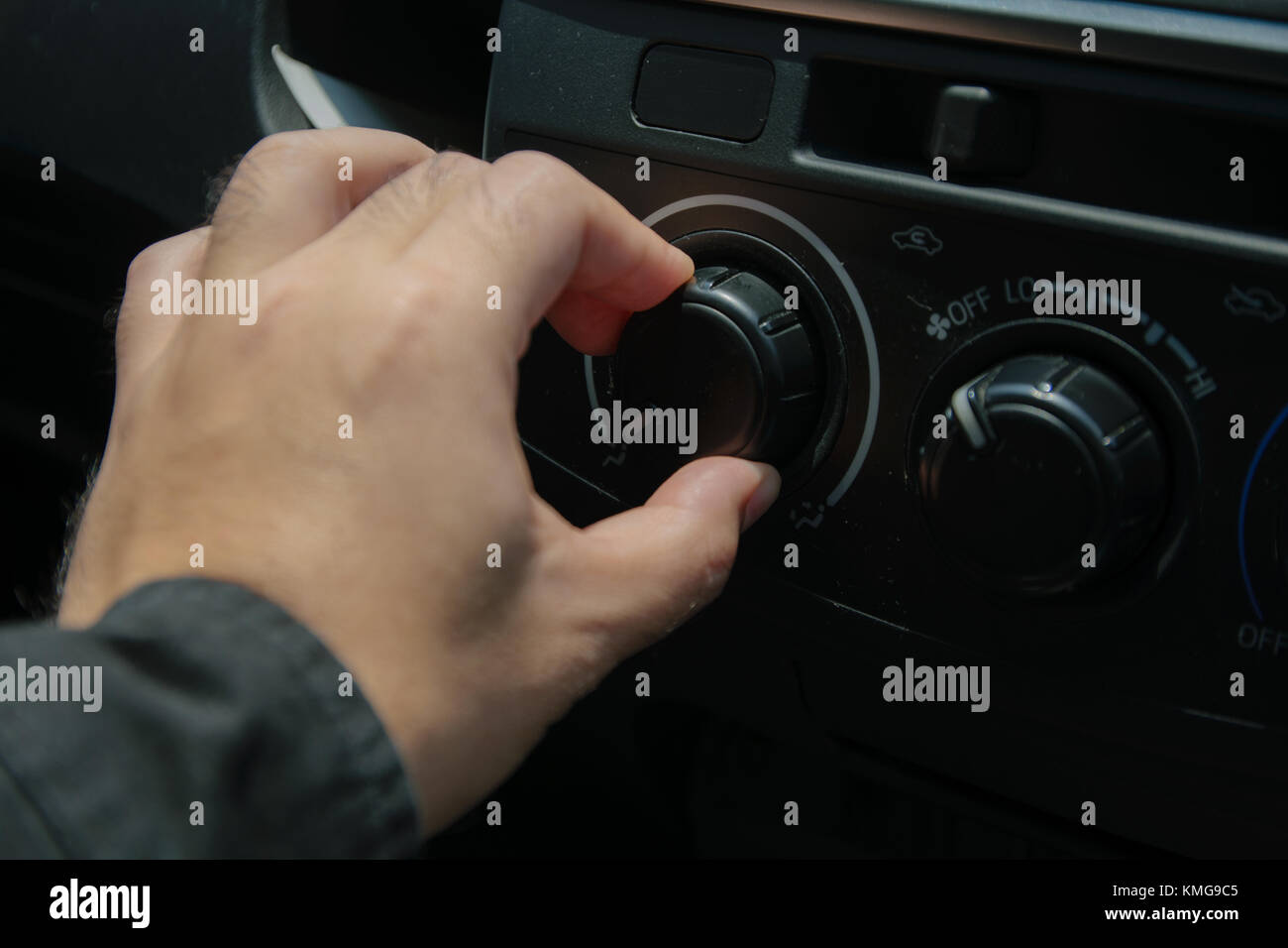 Close-up of man open switch air in car Stock Photo - Alamy