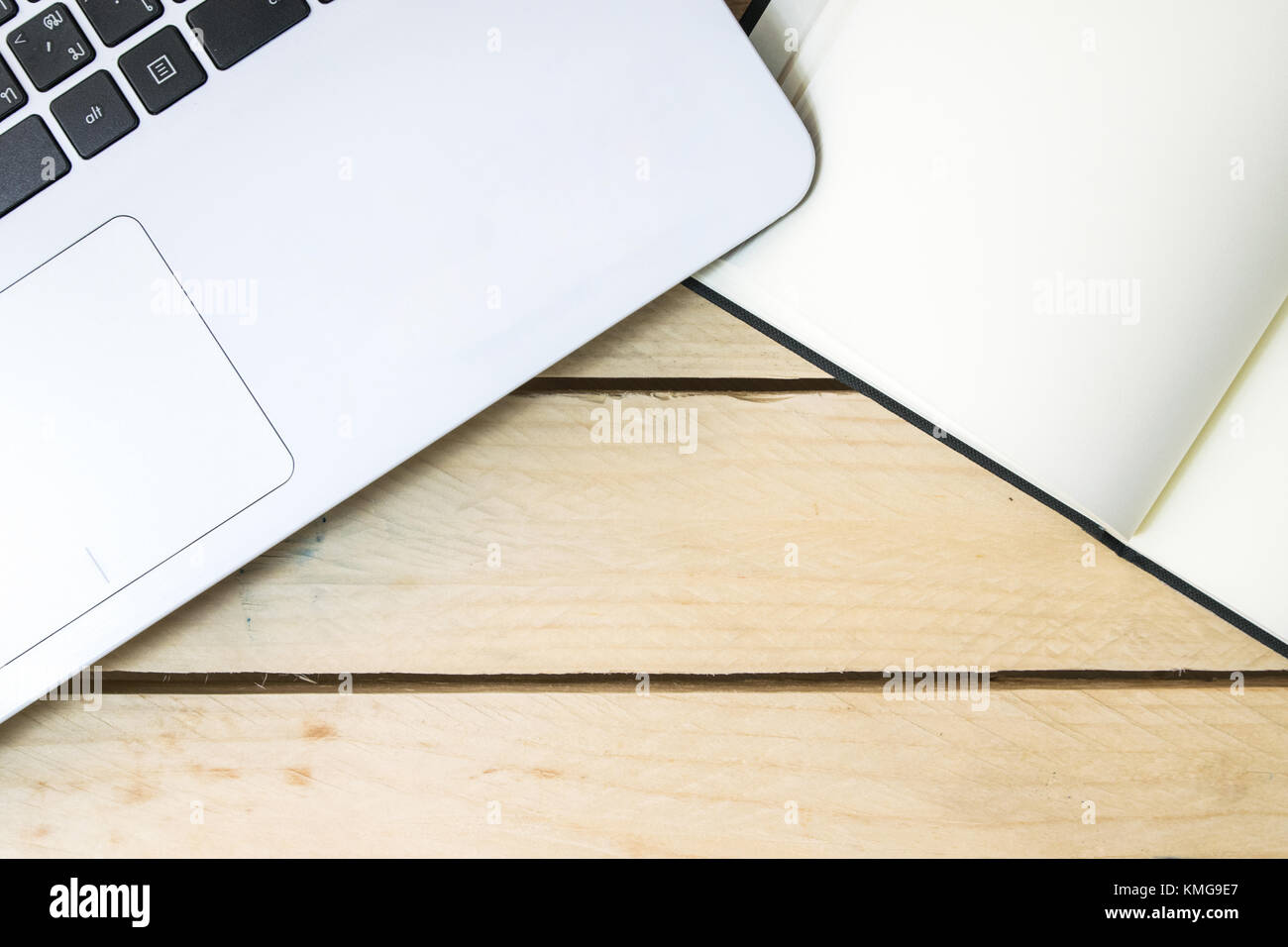 Keyboard With Book on wood background Stock Photo - Alamy