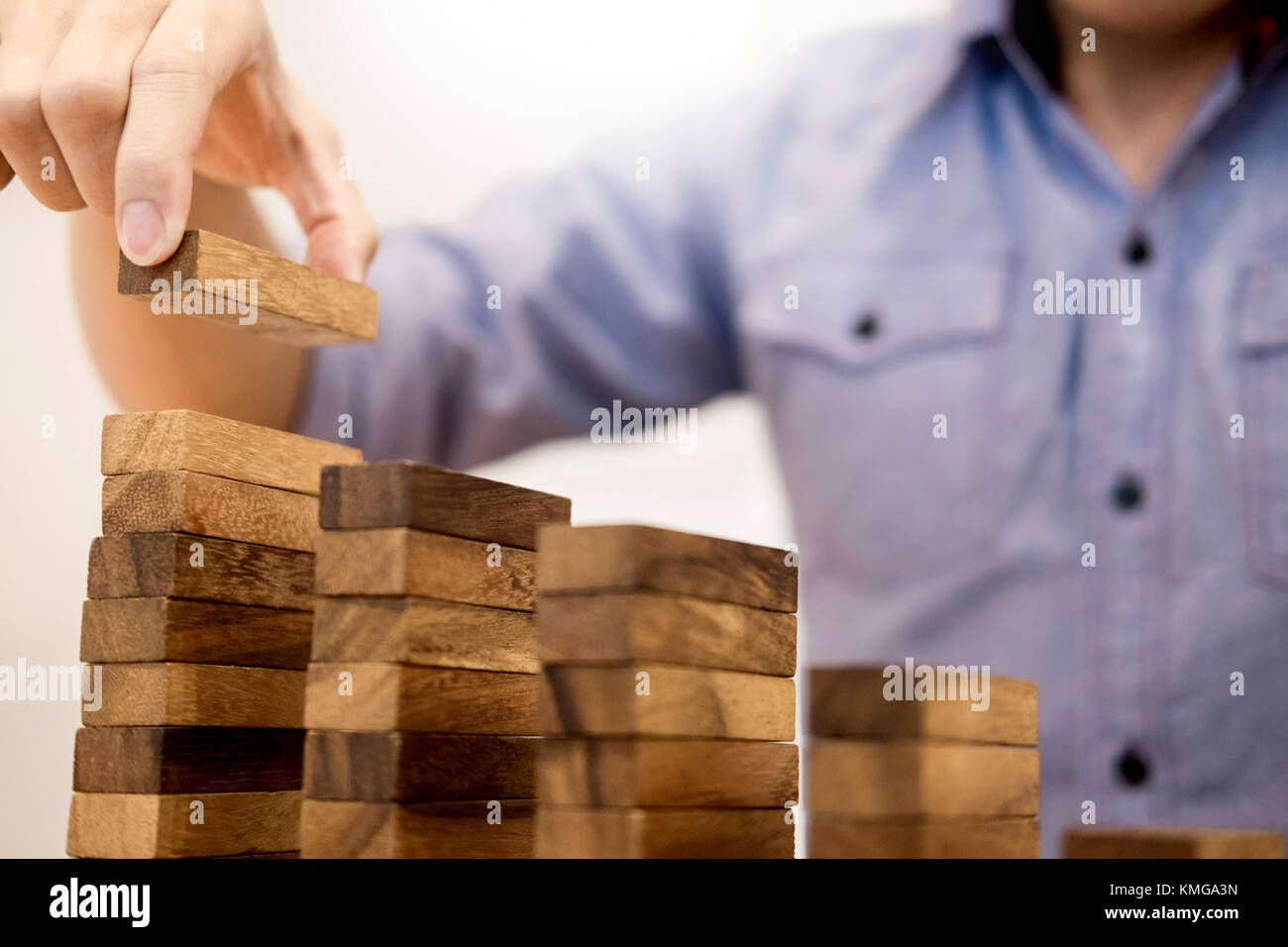 Business man hand put wooden blocks arranging stacking for development ...