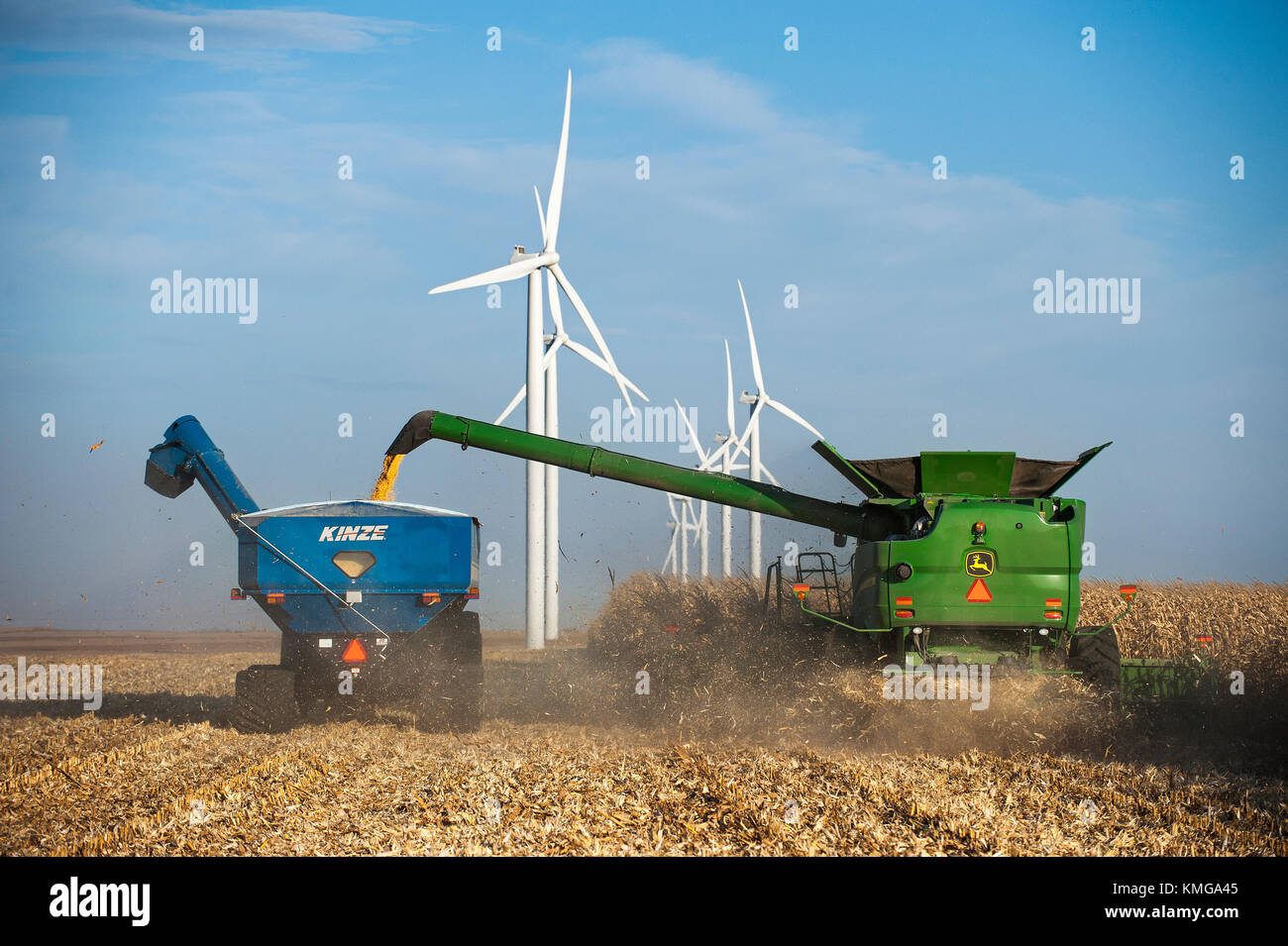 HARVESTING CORN WITH WINDMILLS IN BACKGROUND Stock Photo - Alamy