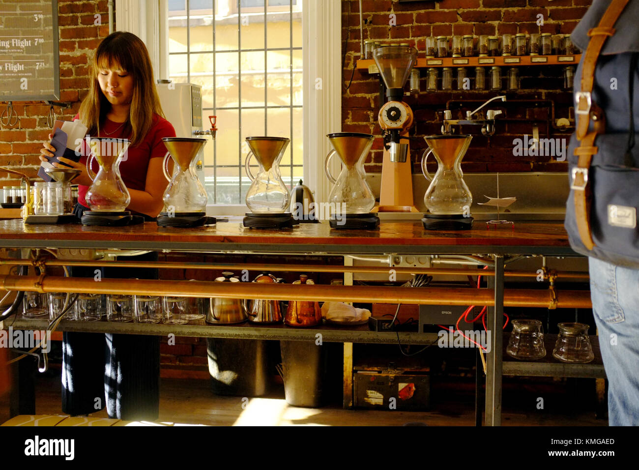 A woman making drip coffee in the Revolver Cafe in Vancouver Stock ...