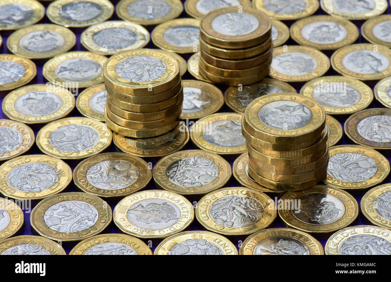 A great number or lot of new one pound coins covering a table and ...