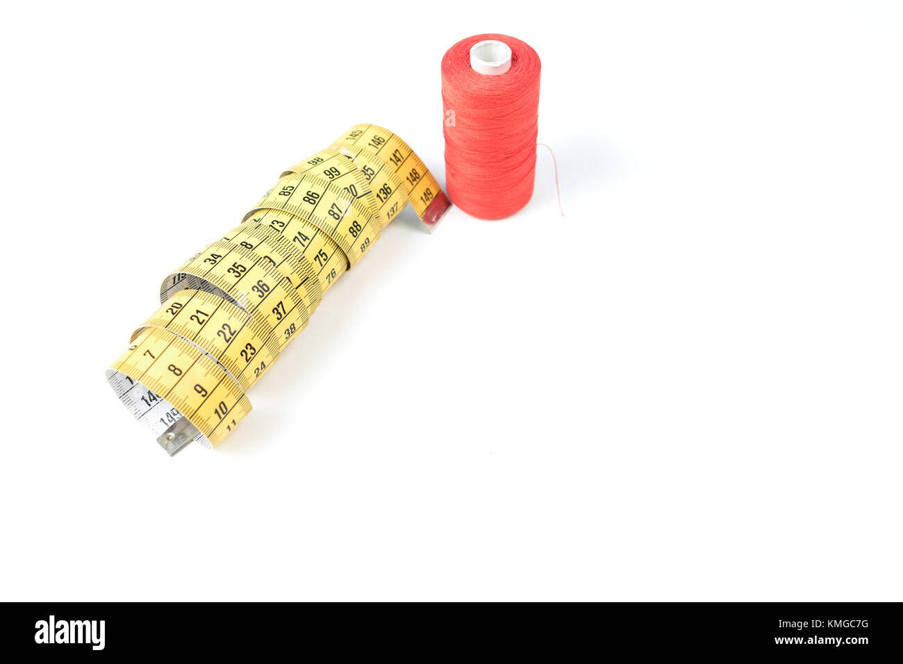 Yellow sewing measuring tape on white background Stock Photo - Alamy