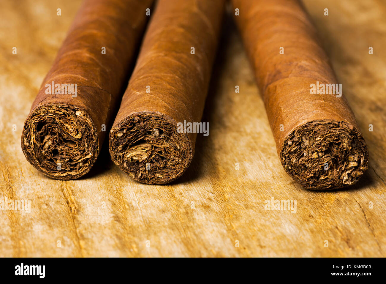 Set of Cuban cigars lying on an old wooden table board Stock Photo - Alamy