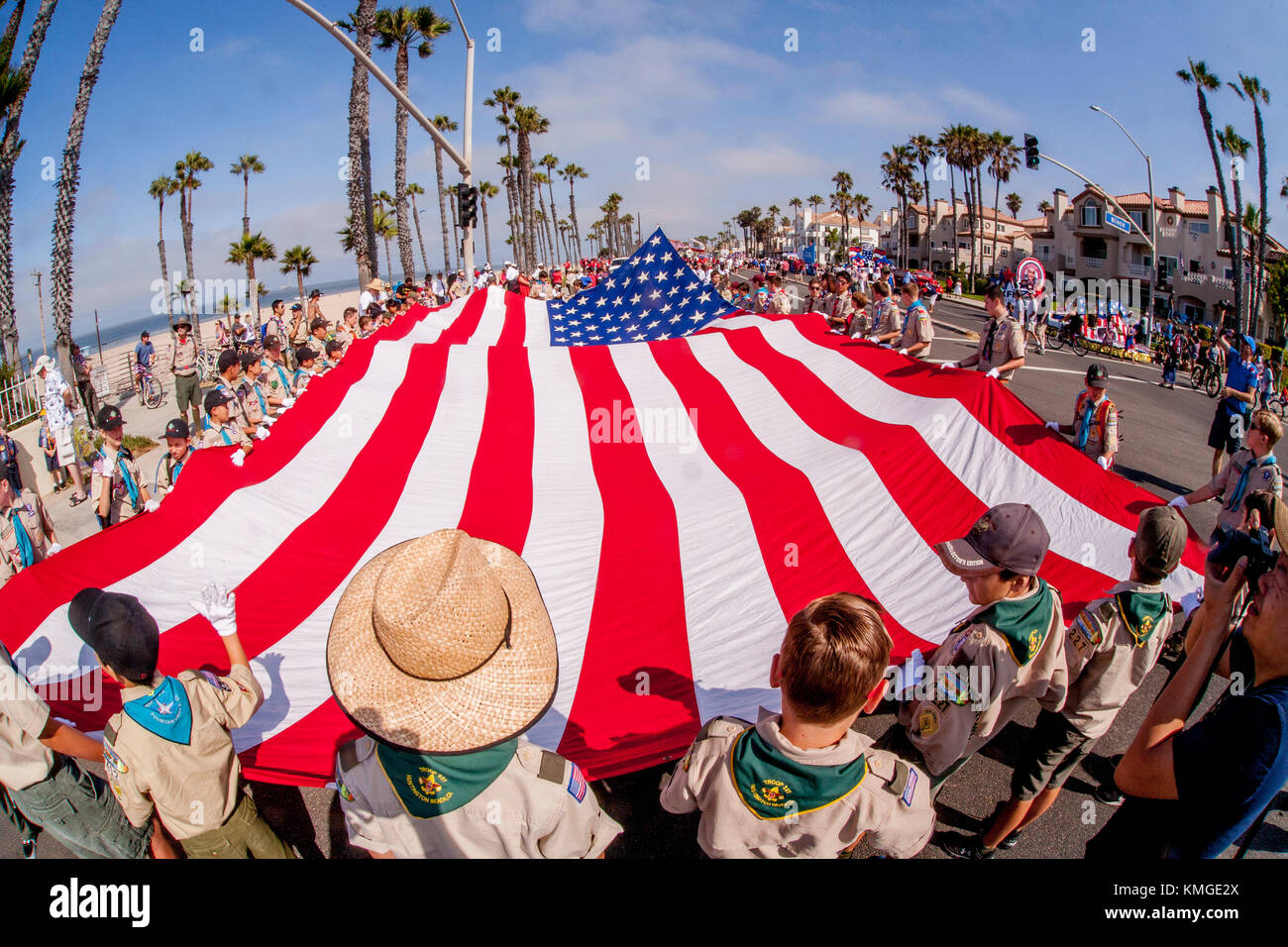 Boy Scouts prepare a large US flag to carry in a July 4th parade in ...