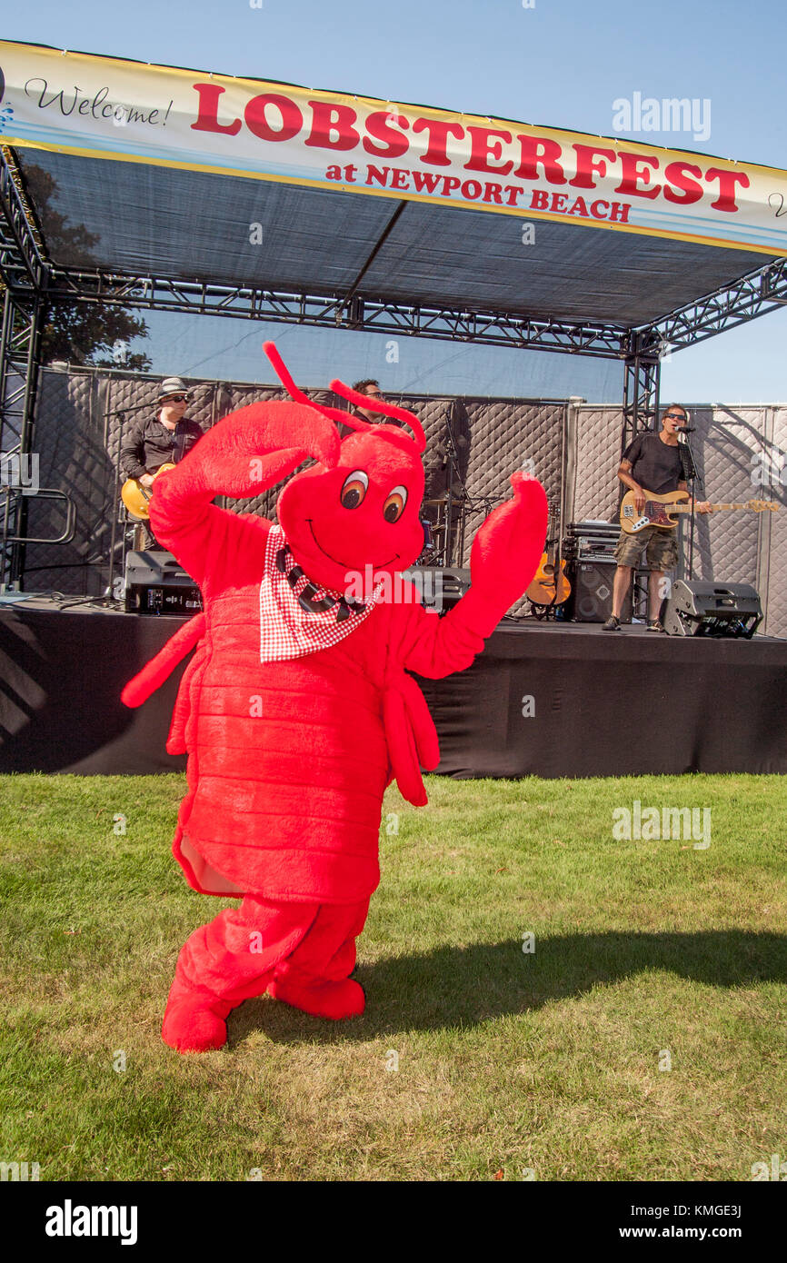 A costumed "lobster" gets a dances to band music at an outdoor ...
