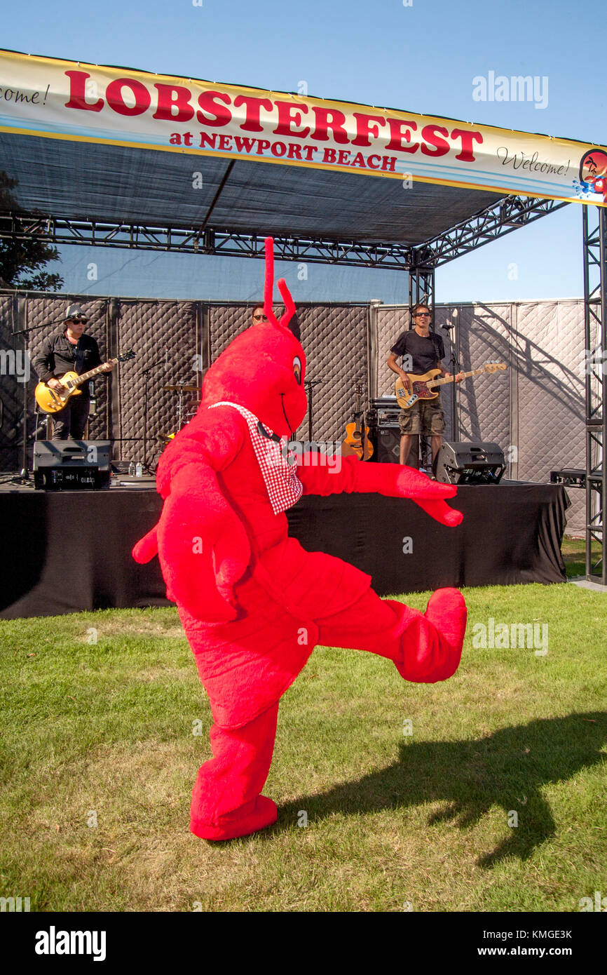 A costumed "lobster" gets a dances to band music at an outdoor ...