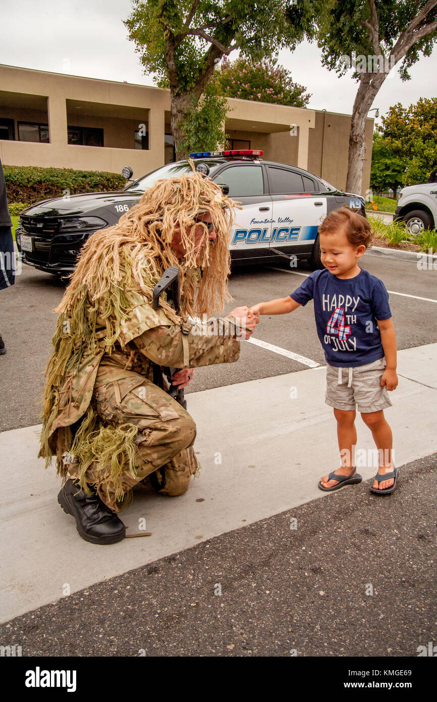 Decked out in SWAT (Special Weapons and Tactics) team camouflage, a ...